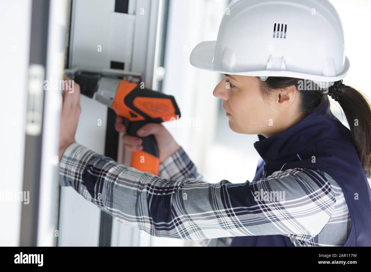 construction worker drilling a window Stock Photo - Alamy