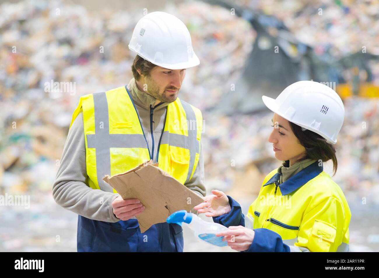 recycling workers researching on the landfill Stock Photo - Alamy