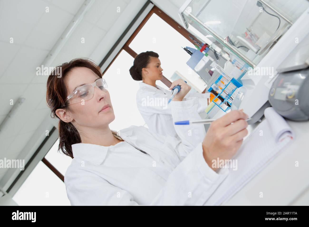 Woman laboratory worker taking notes hi-res stock photography and ...
