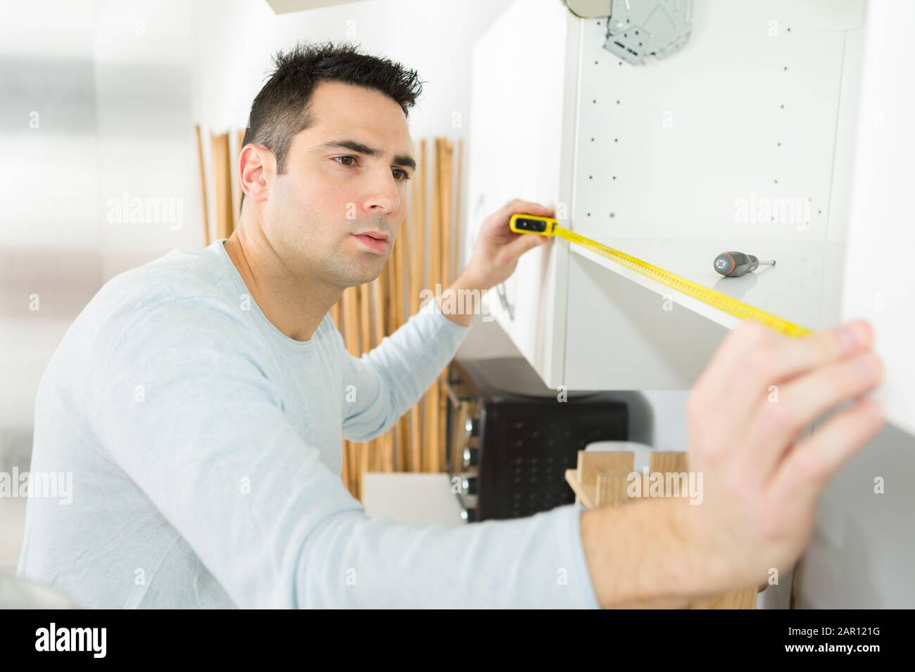 man measuring with measure tape Stock Photo - Alamy
