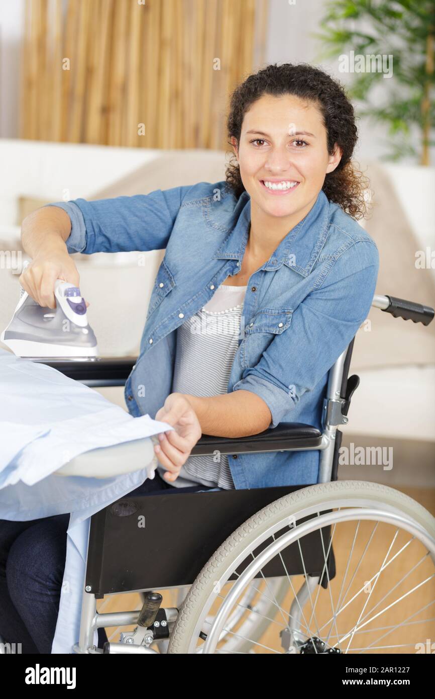 woman in wheelchair house tasks Stock Photo - Alamy