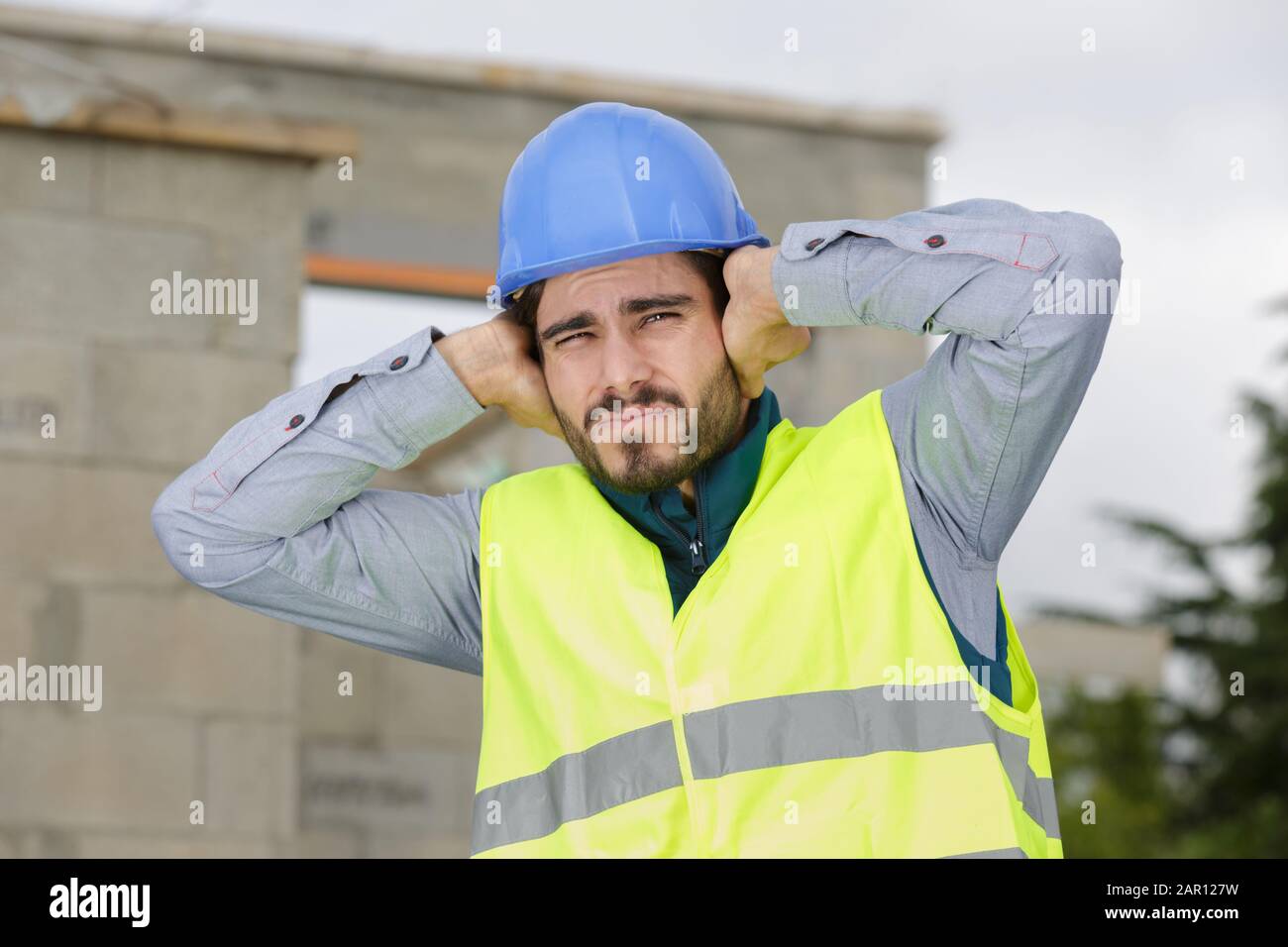 construction worker or engineer covering his ears Stock Photo - Alamy