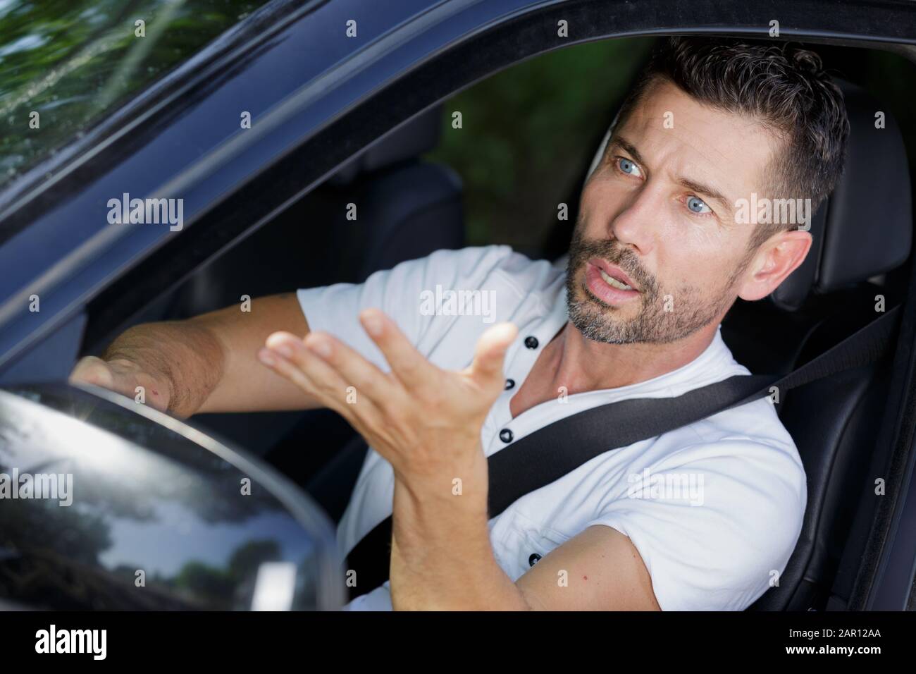 driver making gesture of frustration from his window Stock Photo - Alamy