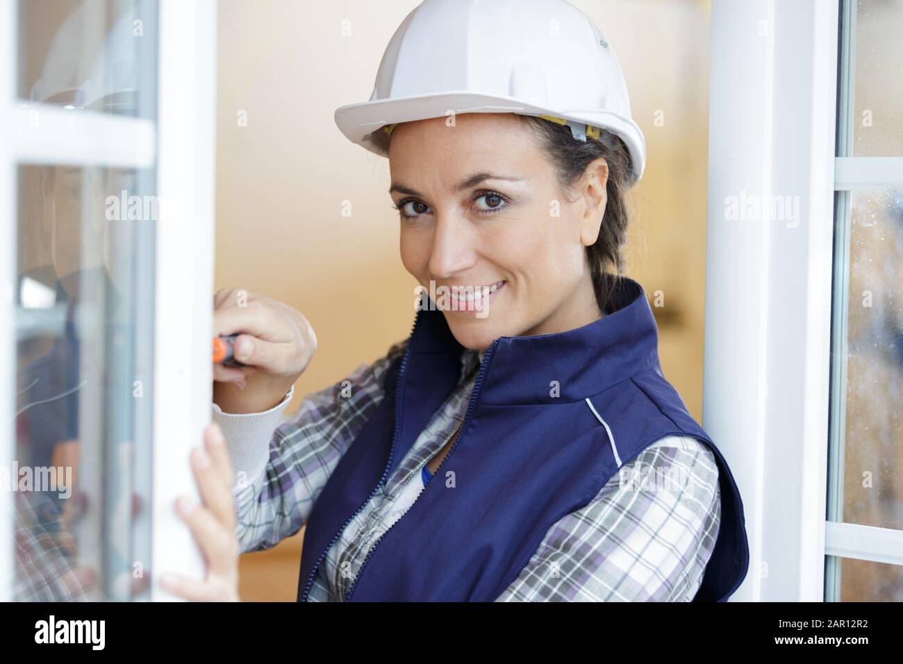 a female builder fixing the window Stock Photo - Alamy