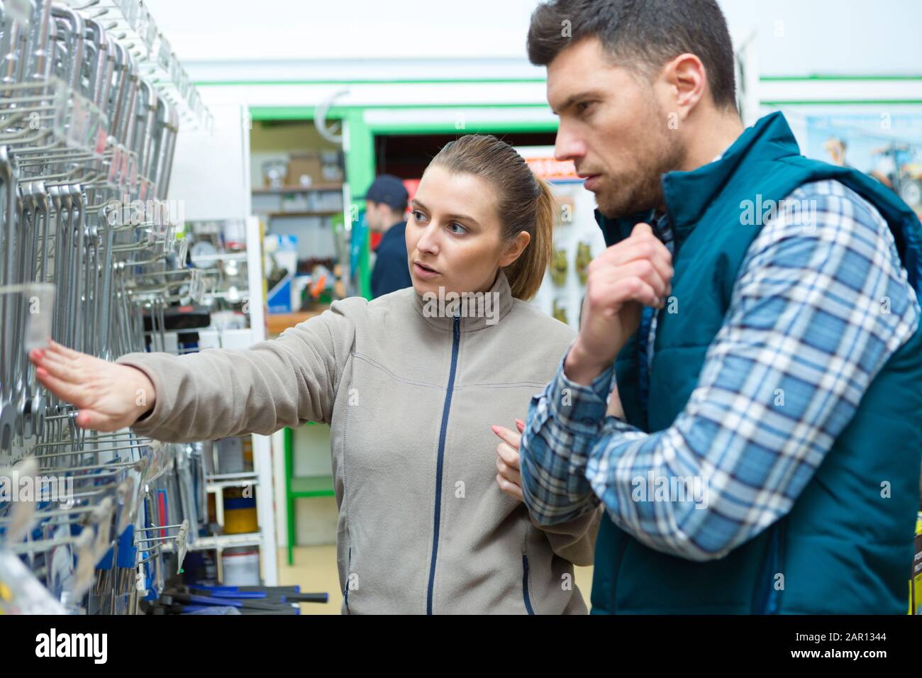 woman selling tools in a warehouse Stock Photo - Alamy