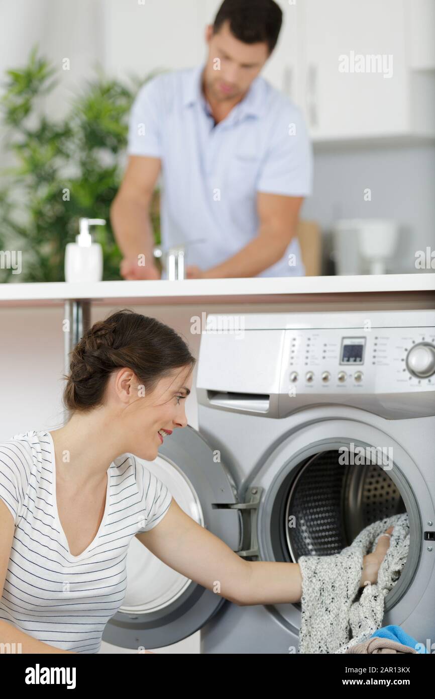 happy housewife woman in laundry room with washing machine Stock Photo ...