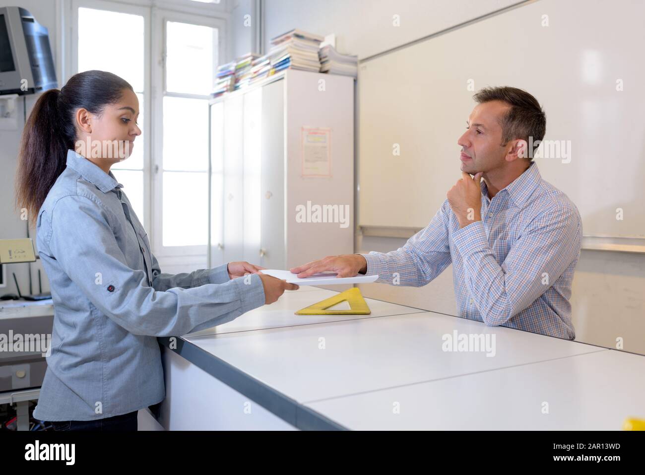 female student with professor in modern classroom Stock Photo - Alamy