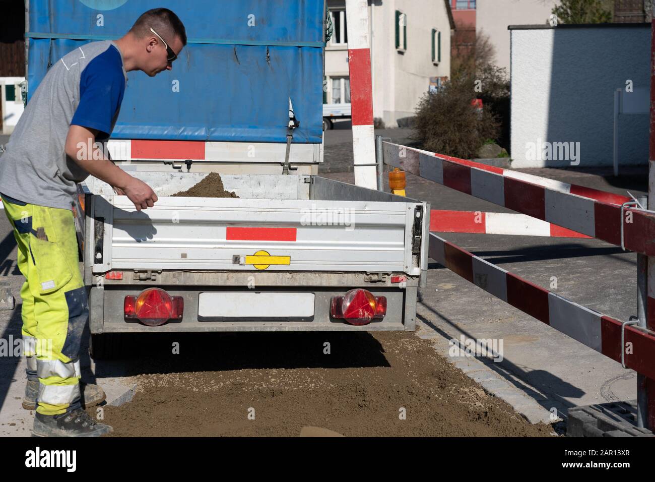 Young Pipeline technician on construction site closes tailgate of a ...
