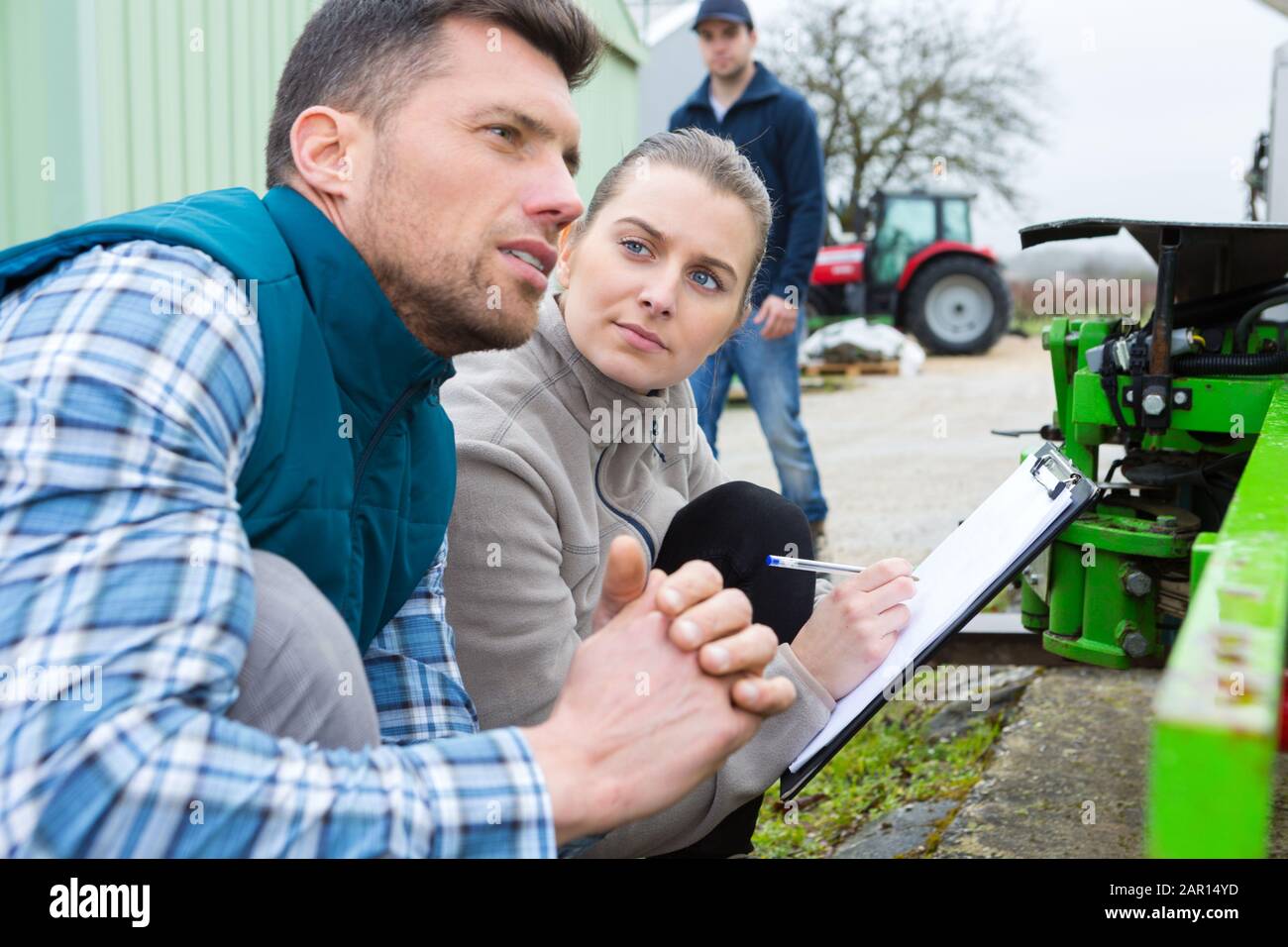 two farm workers talking outside Stock Photo - Alamy