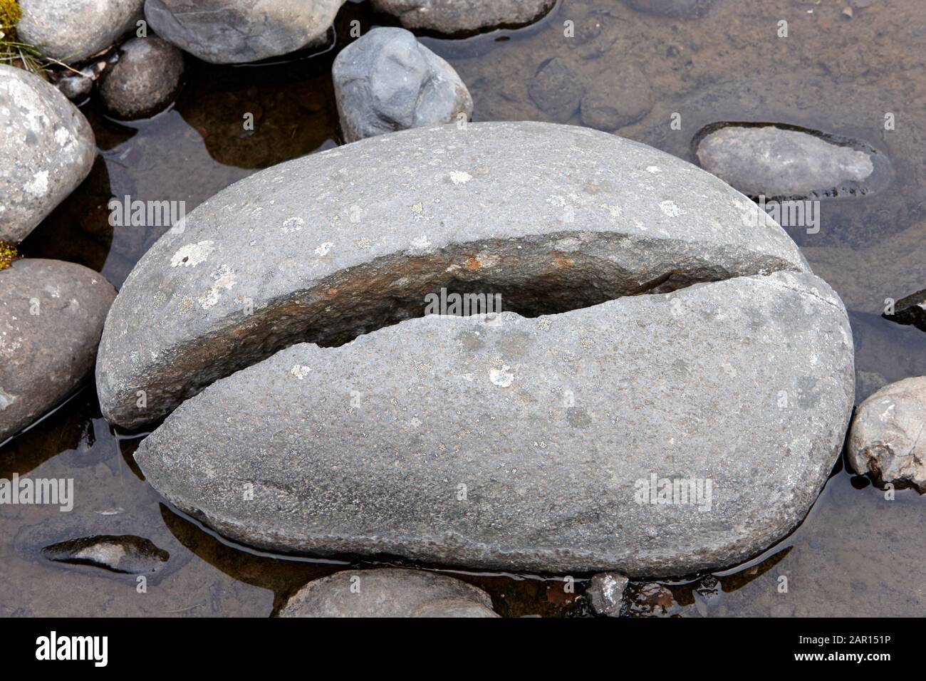 split rock boulder lying in stream in vatnajokull national park iceland ...