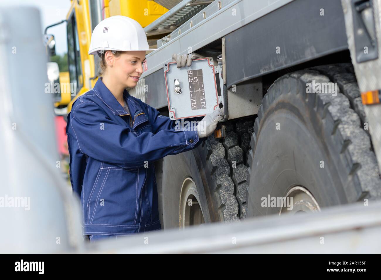 woman operating controls on an industrial vehicle Stock Photo - Alamy