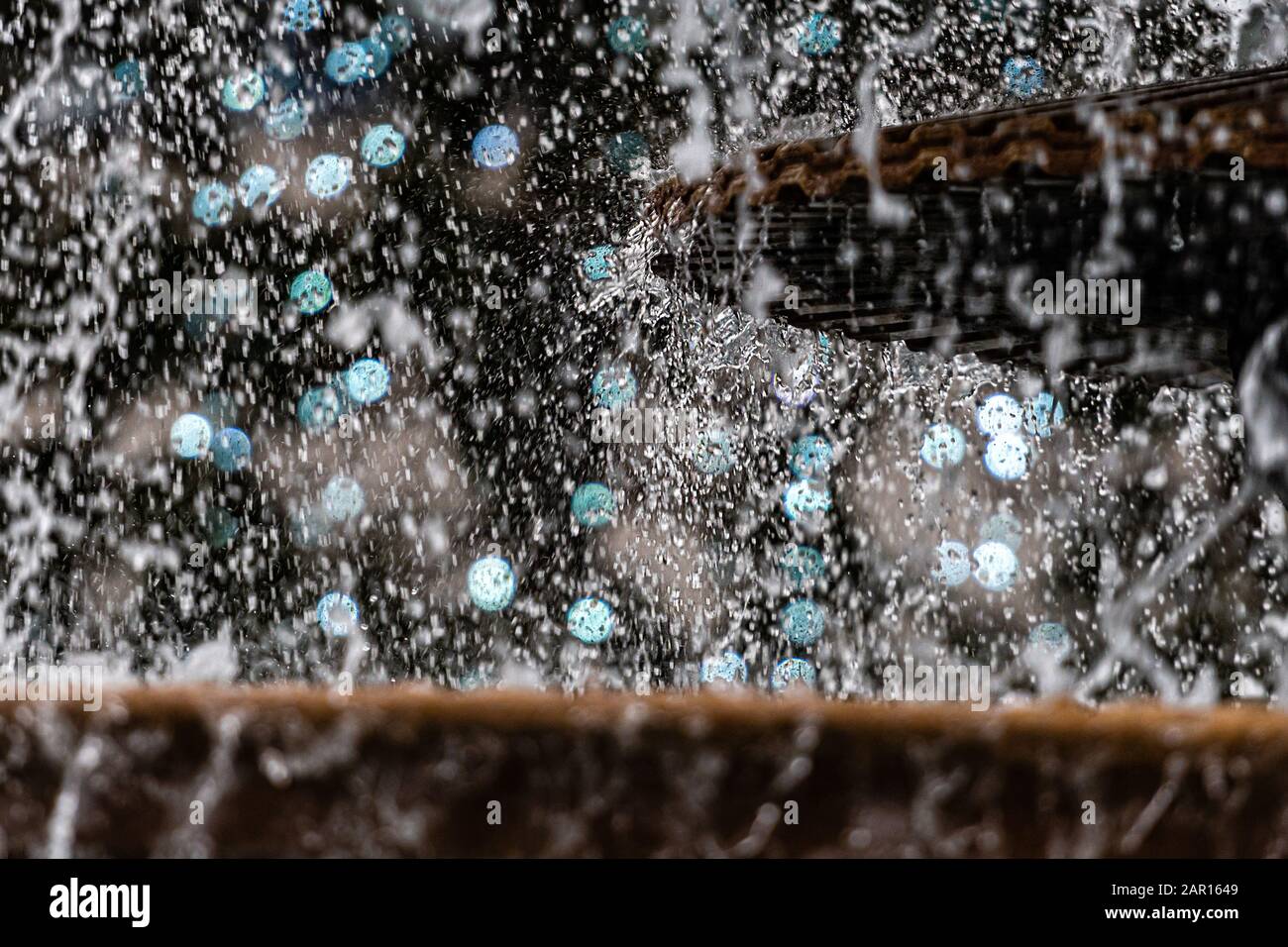 A close-up of a splash of water with a Christmas garland in a defocused ...