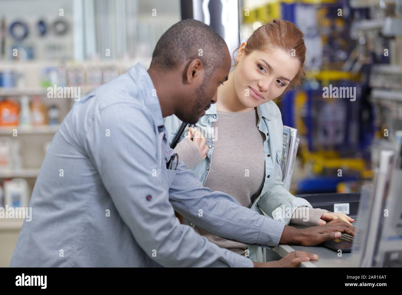 customer and male worker in hardware store Stock Photo - Alamy