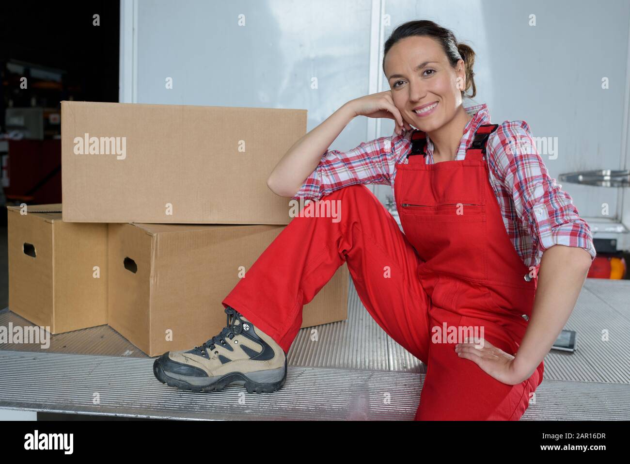 female logistician posing next to boxes Stock Photo - Alamy