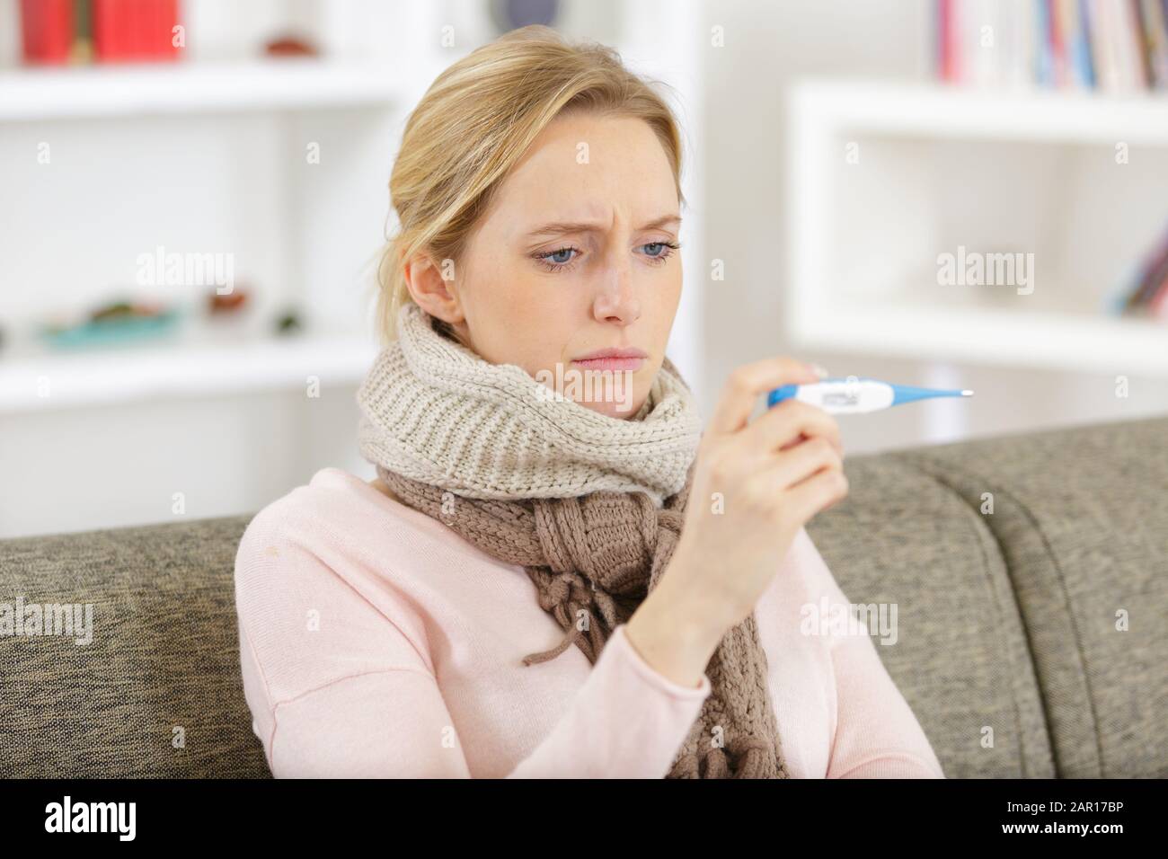 woman being sick having flu lying on sofa Stock Photo - Alamy