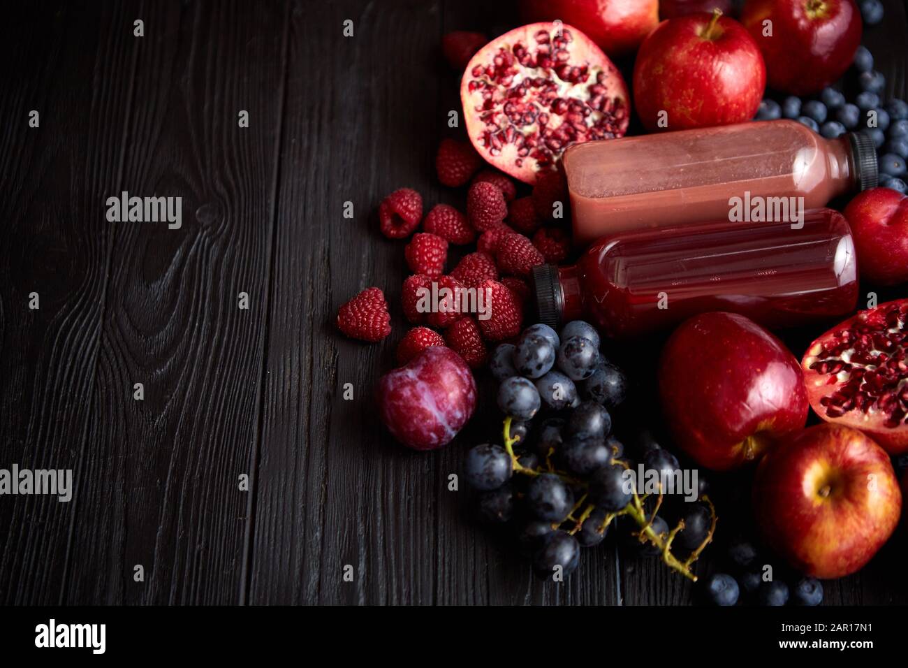 Mix of fresh red and black fruits. With botteled fresh juices Stock ...