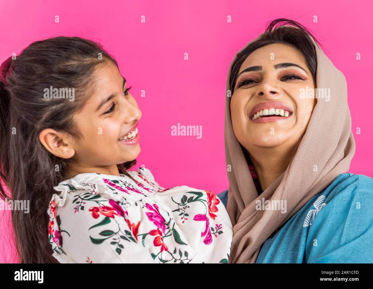 Middle eastern family with traditional emirates dresses posing in a ...