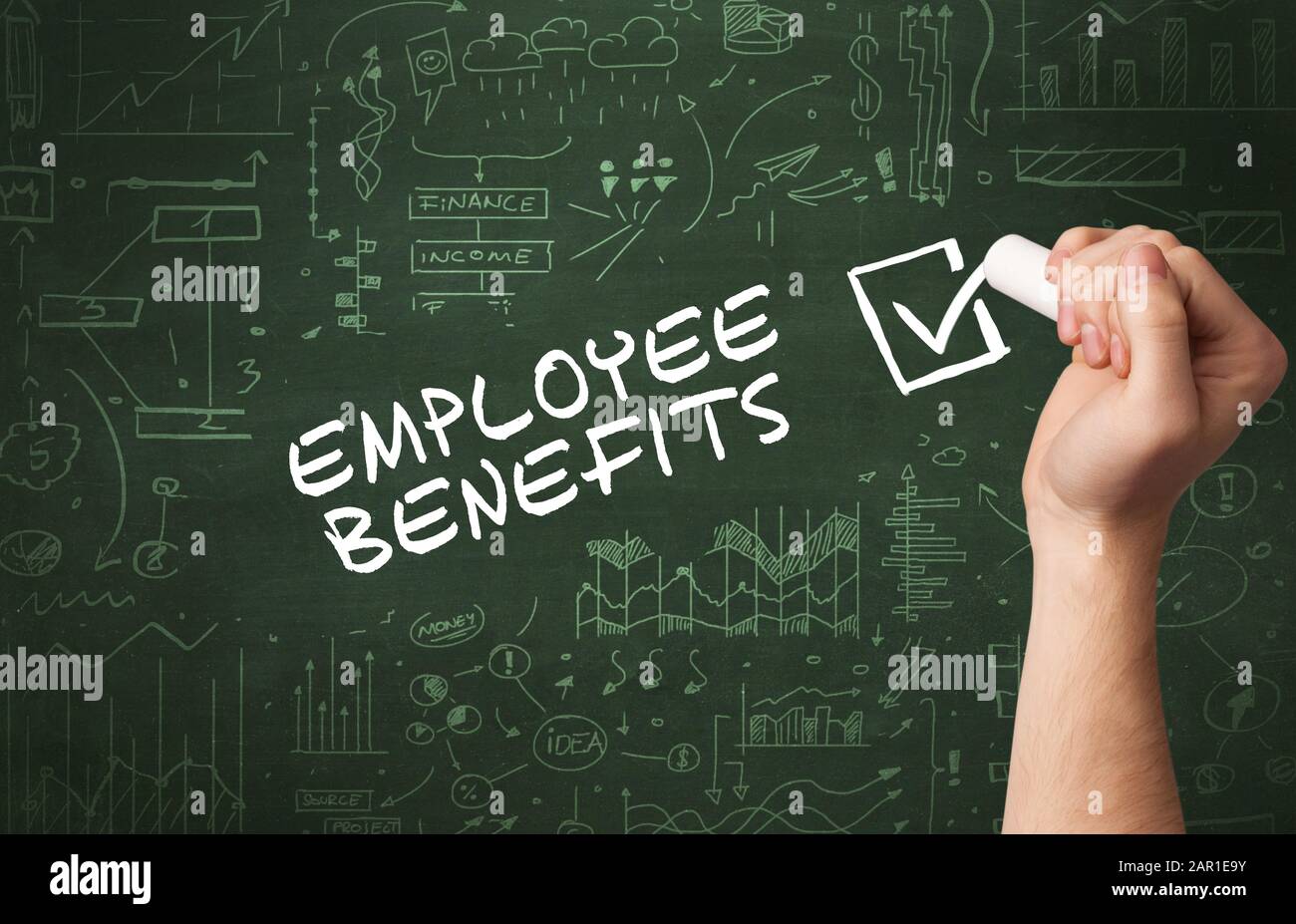 Hand drawing EMPLOYEE BENEFITS inscription with white chalk on ...