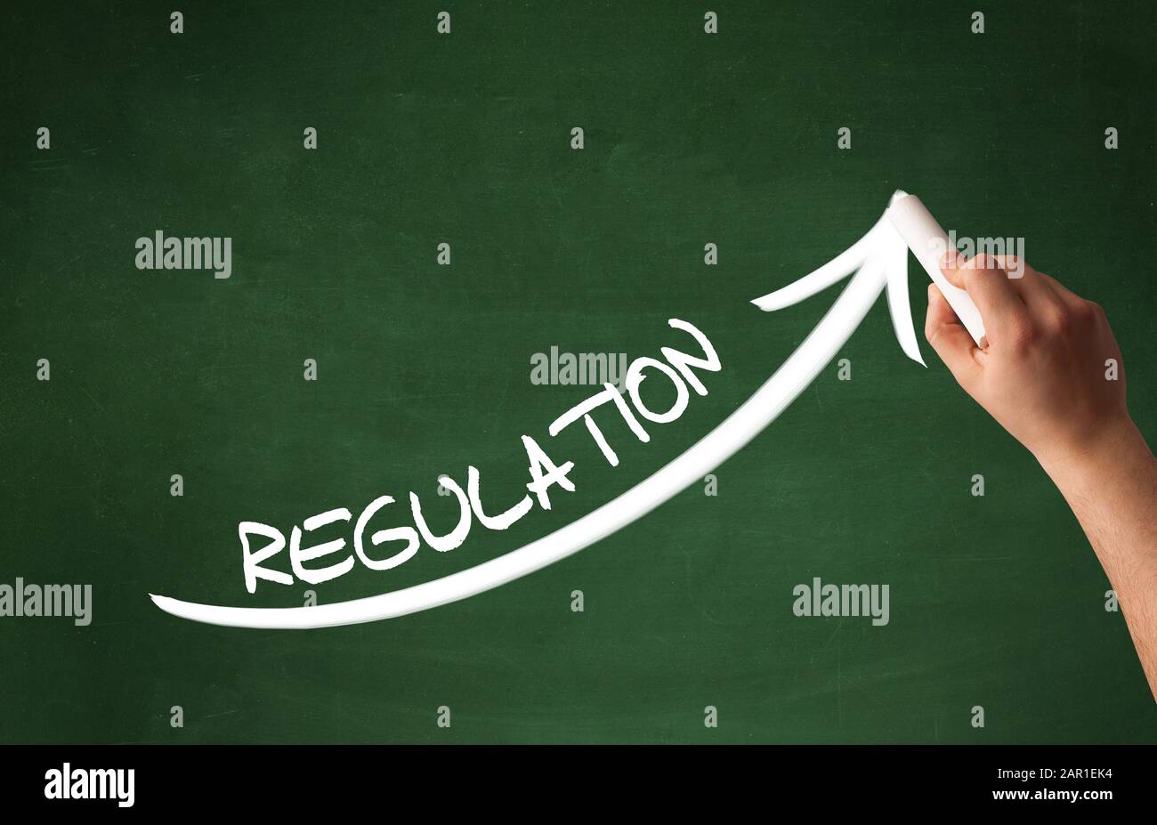Hand drawing REGULATION inscription with white chalk on blackboard ...