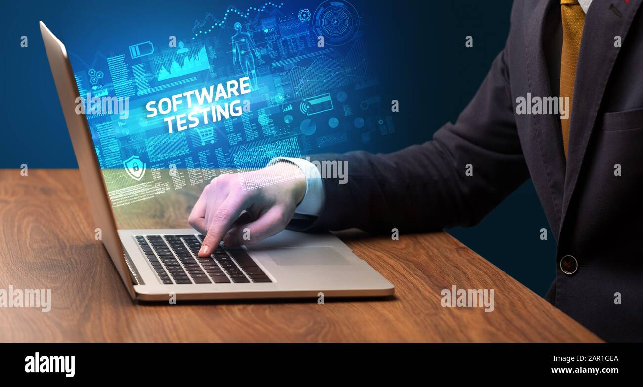 Businessman working on laptop with SOFTWARE TESTING inscription, cyber ...