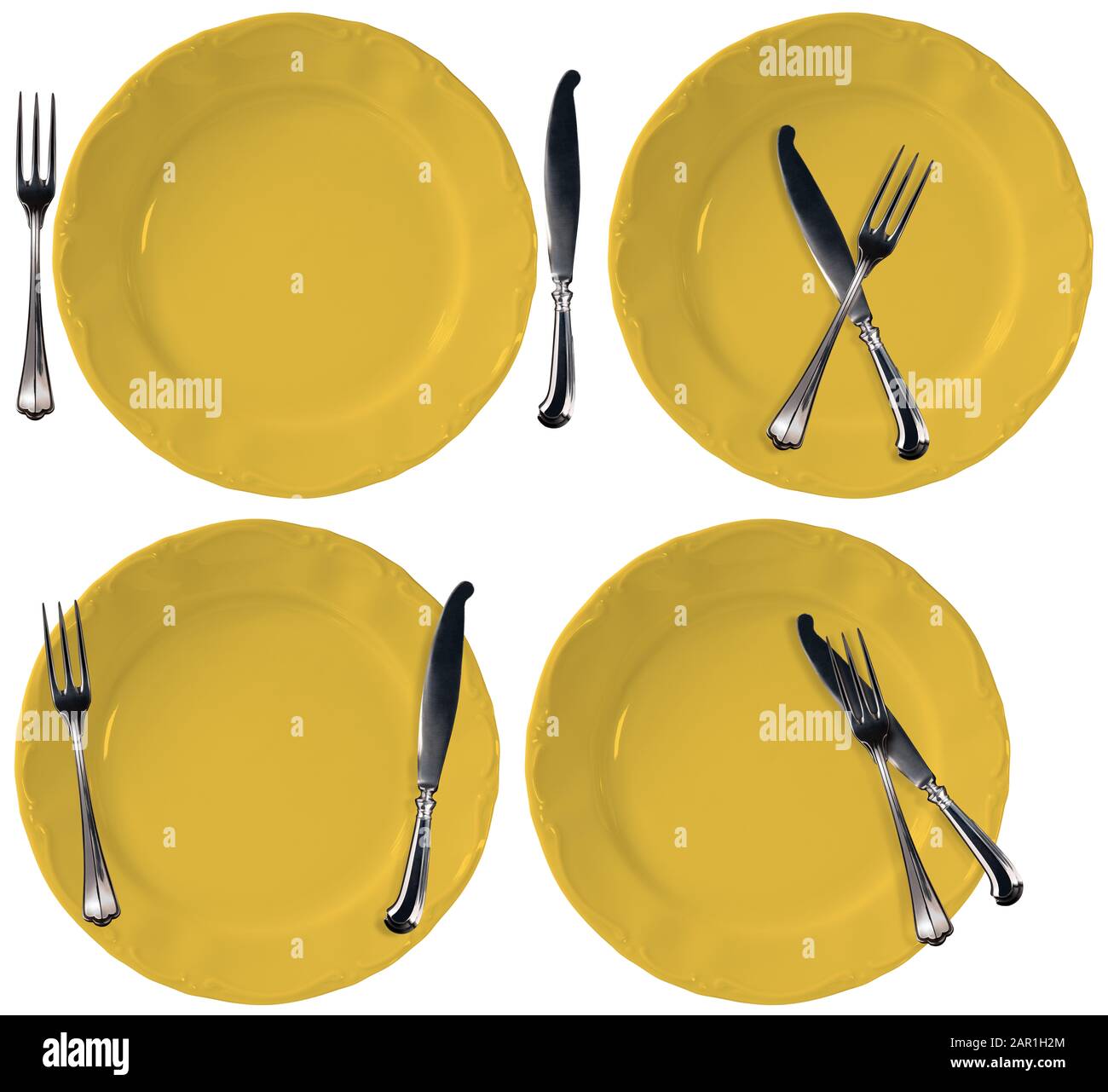 Collection of four yellow empty plates, serving dishes, with cutlery ...