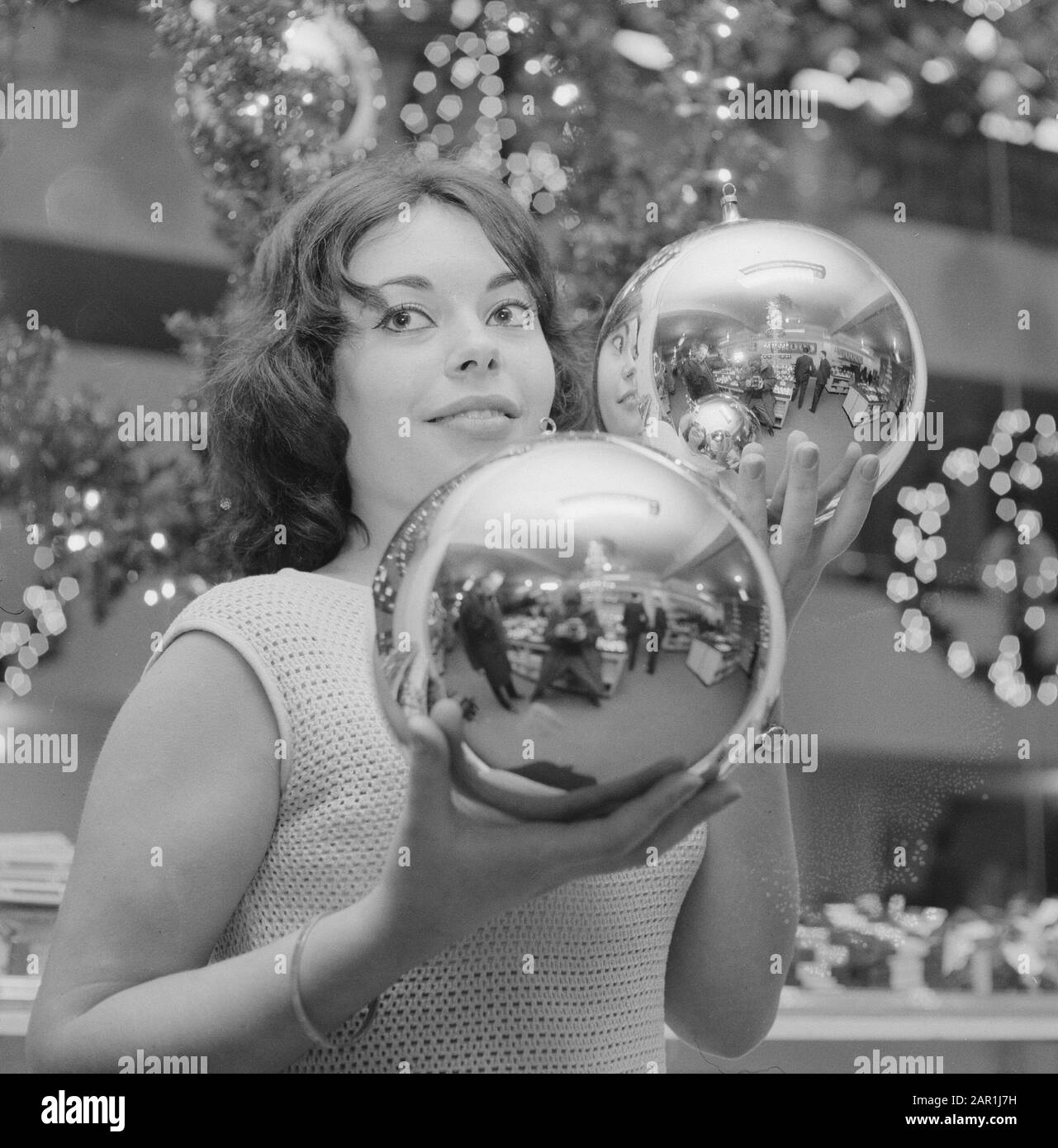 Christmas approaching; young woman shows big Christmas balls Date ...