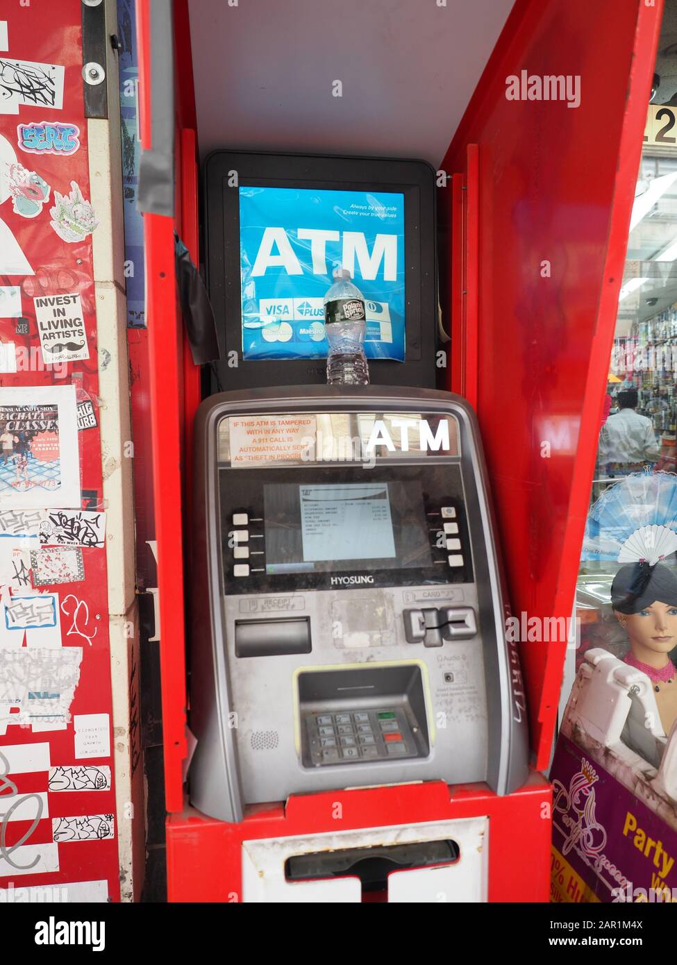 New York, USA - July 1, 2019: Image of a red ATM machine in the streets ...