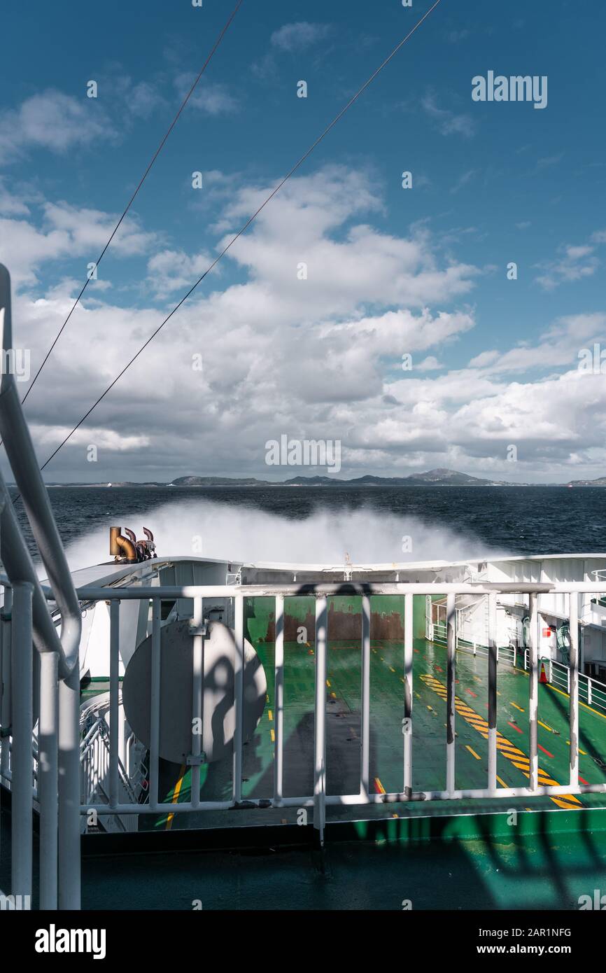 Harsh sea between Mortavika and Arsvågen with water spraying on the car ...
