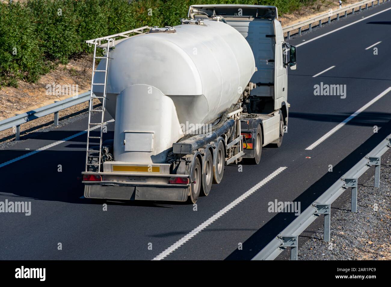 Tank truck driving on the highway Stock Photo - Alamy