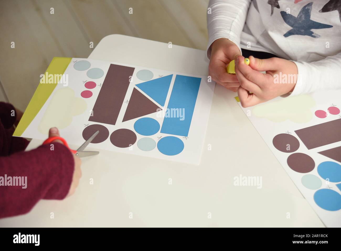 child cuts out details of application. Children at nursery school ...