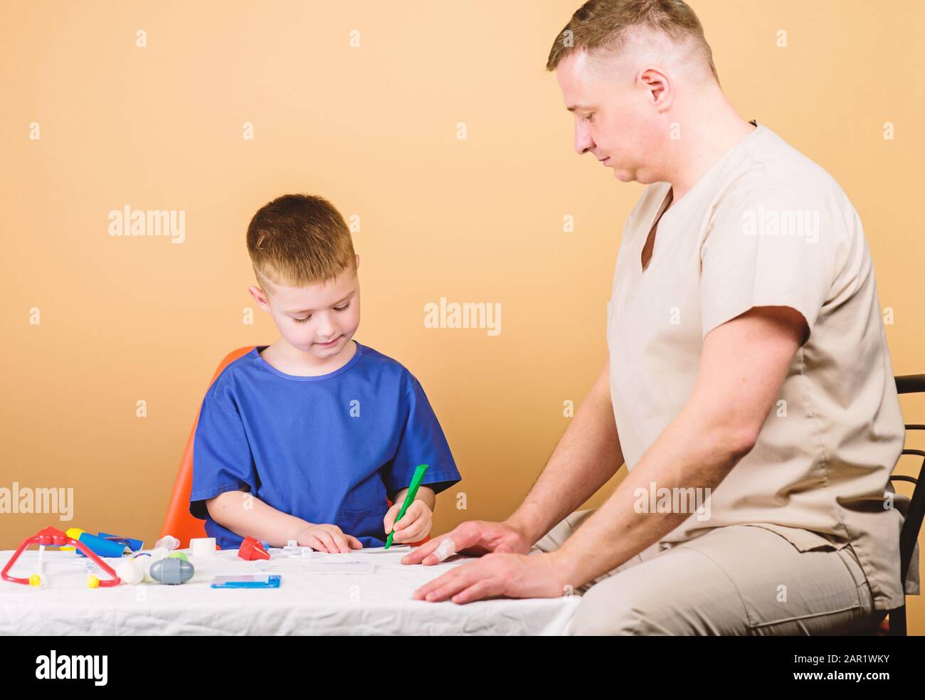 Boy cute child and his father doctor. Hospital worker. First aid ...
