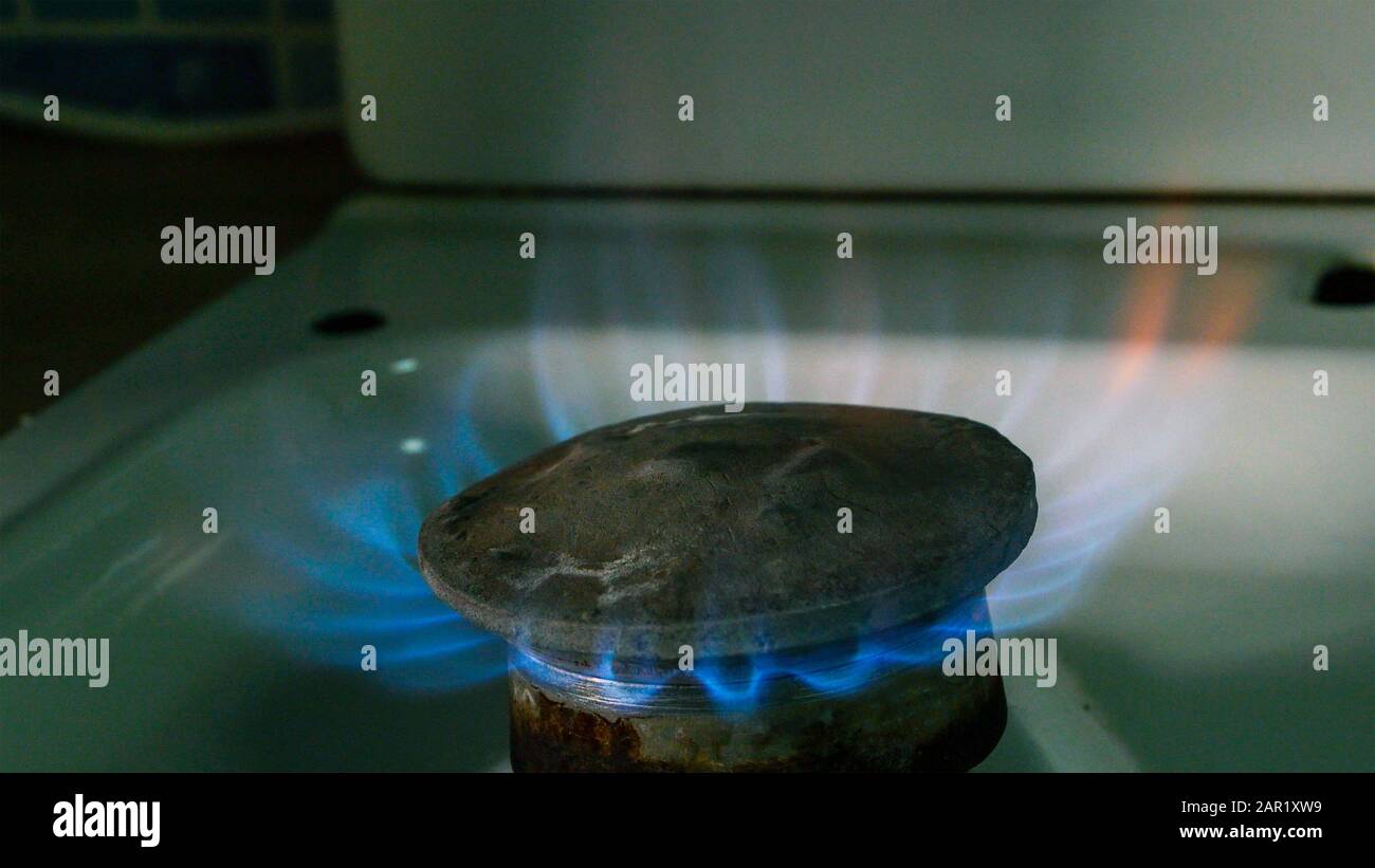 Natural gas burning. Fire from old burner stove top, in domestic ...