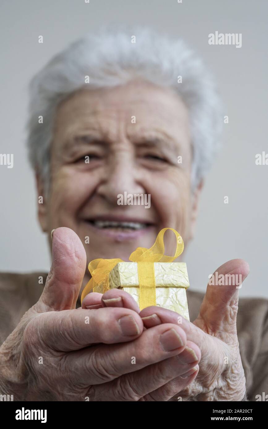 Grandma holding wrapped gift hi-res stock photography and images - Alamy