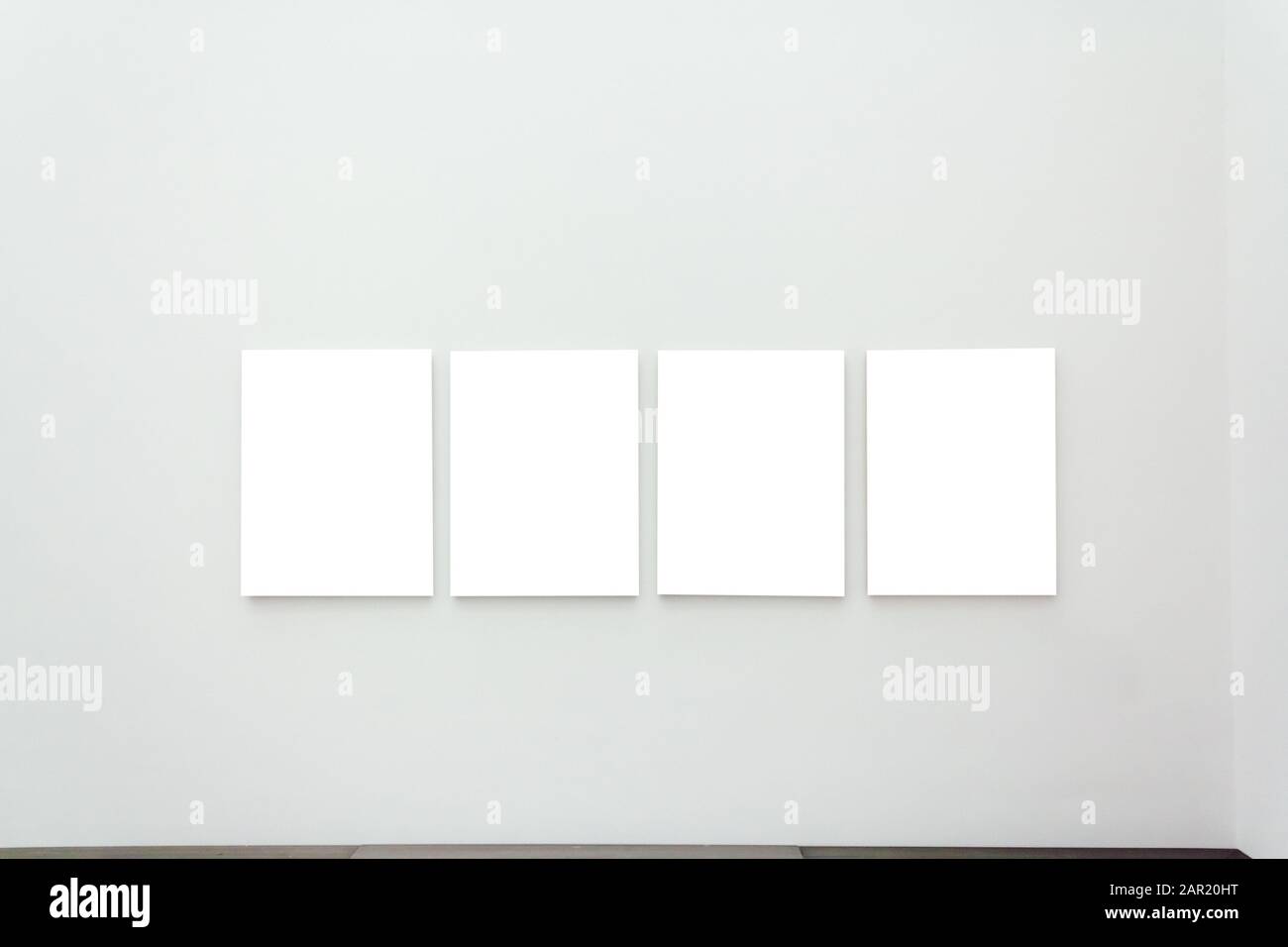 Square white surfaces attached to a wall in a room Stock Photo - Alamy