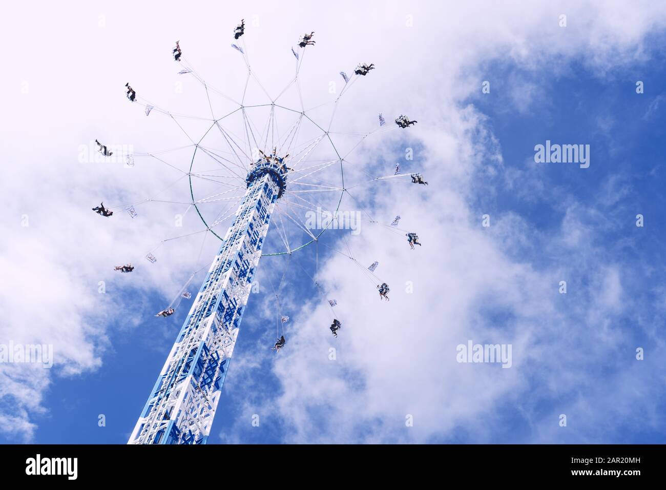 Low angle shot of a circular carousel revolving under a sky full of ...