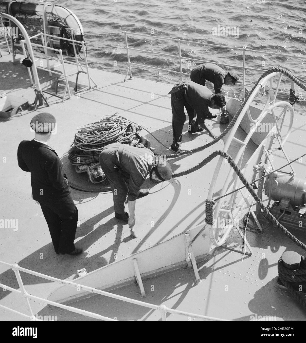 Sailors working on deck of ship while officer watching Date: 19 ...