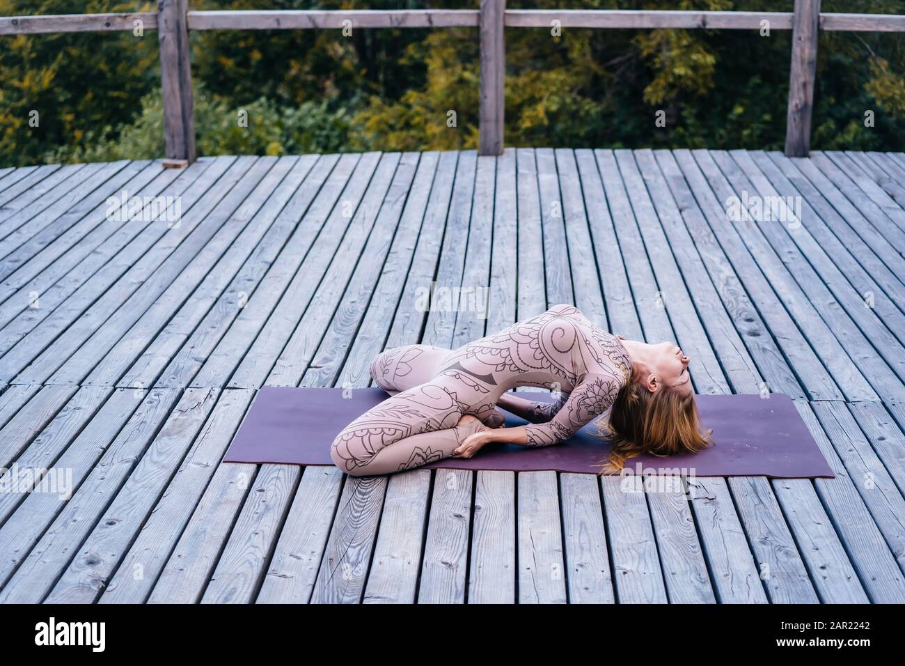 A woman practices yoga at the morning in a terrace on a fresh air Stock ...