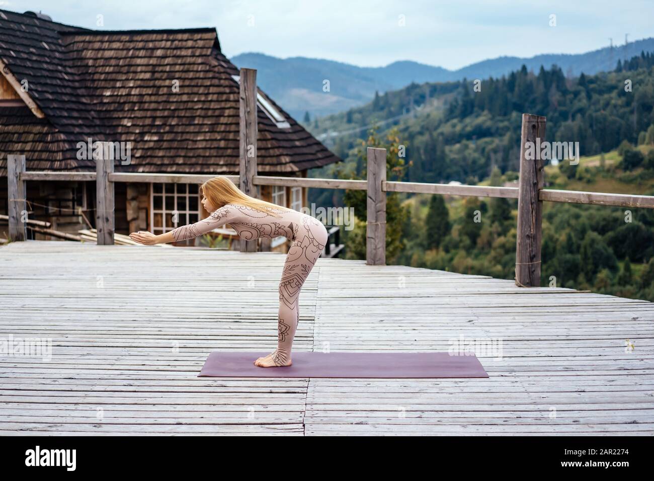A woman practices yoga at the morning in a terrace on a fresh air Stock ...