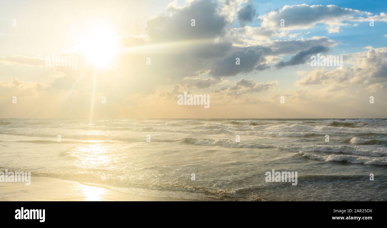 Waves roll on the beach. Quiet beautiful golden sunset on the sea ...