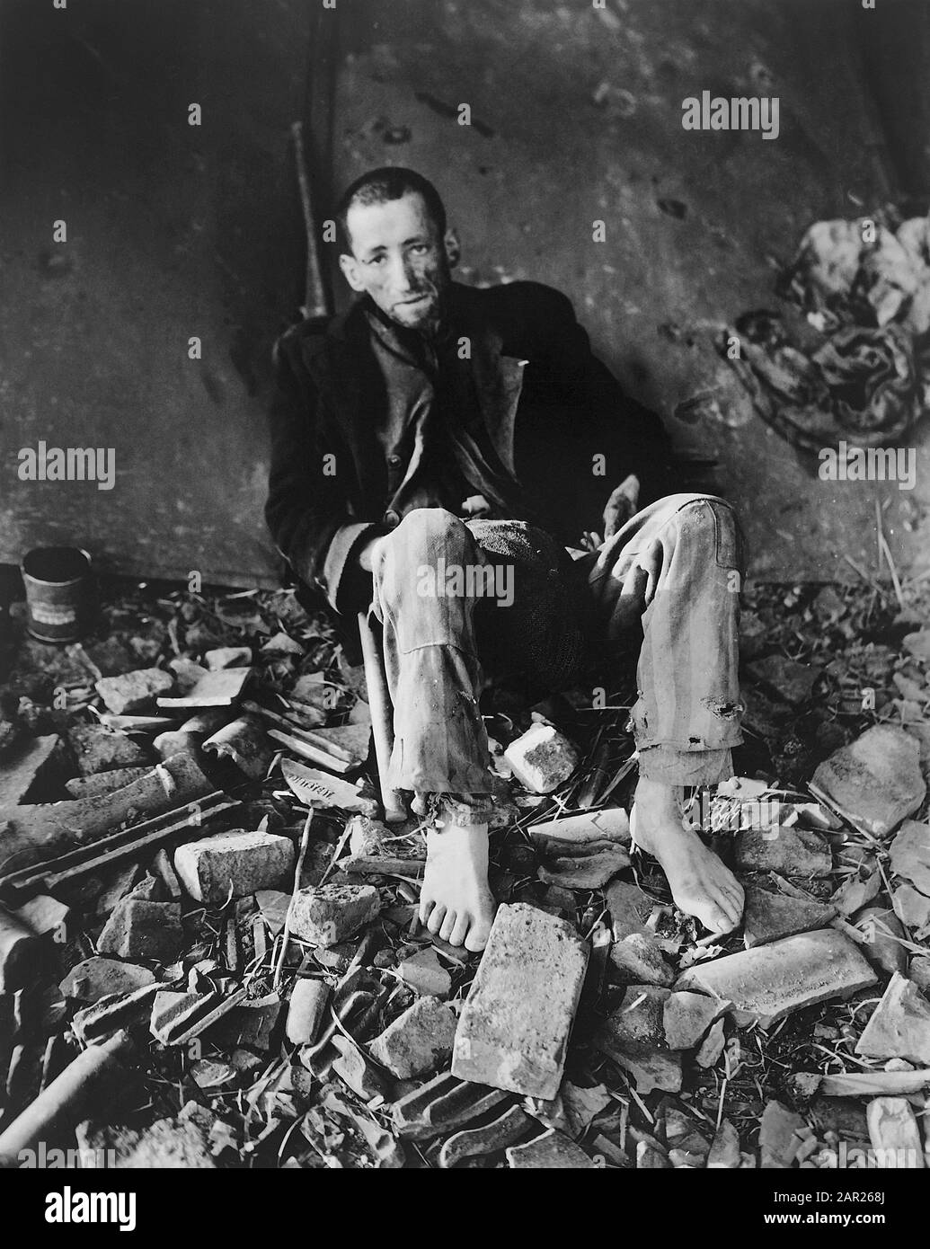 French Prisoner sitting in Rubble waiting for Ambulance to take him to ...