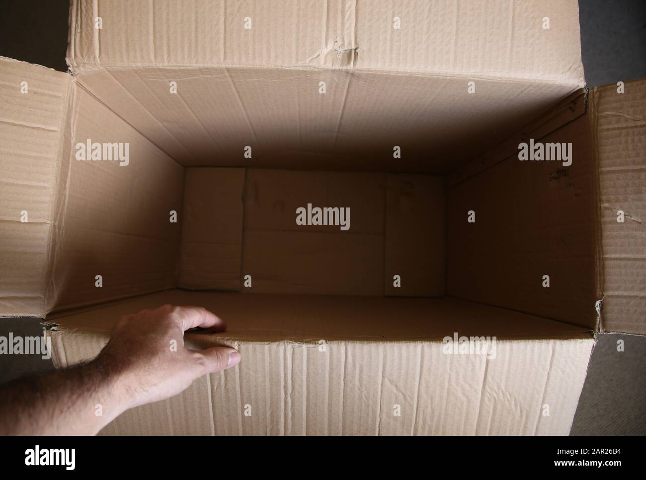 High angle shot of a person opening an empty cardboard box Stock Photo ...