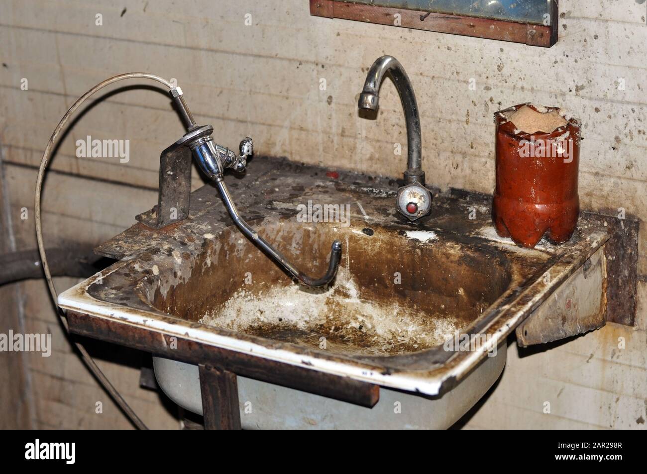 Dirty old sink for washing the hands of a workshop in a factory ...