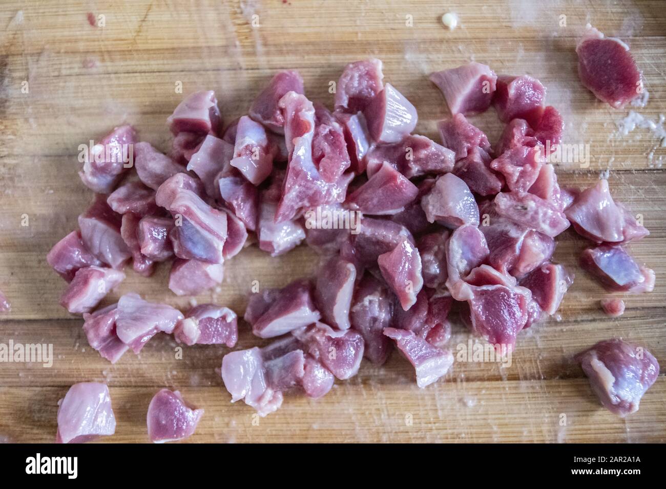 the fresh red pieces sheep meat was preparing in the kitchen by ...