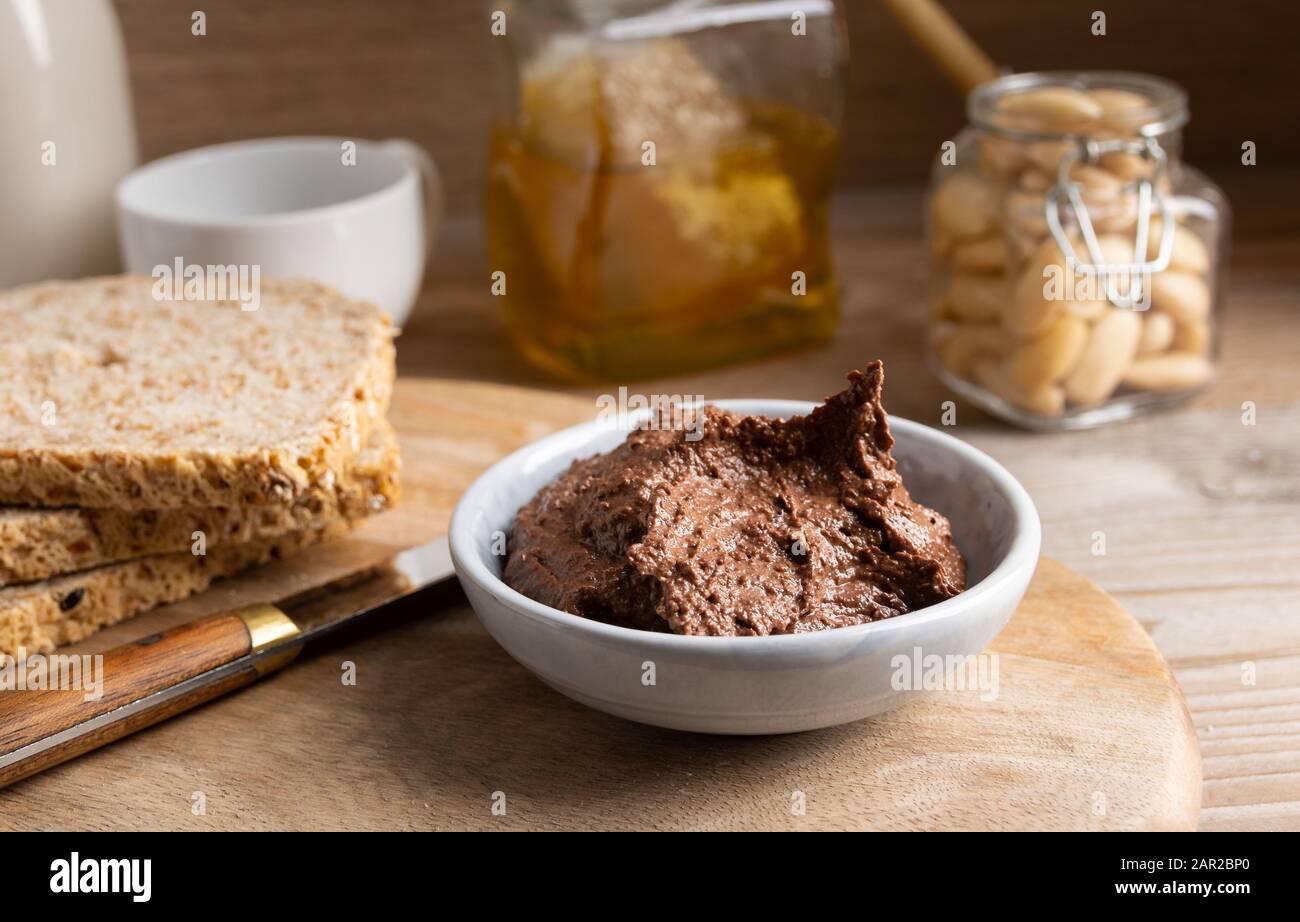 Homemade vegan chocolate spread in a small bowl made of almond butter ...