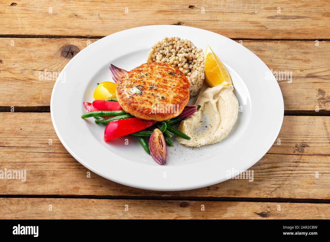 Salmon cutlet with roasted vegetables and green buckwheat Stock Photo ...
