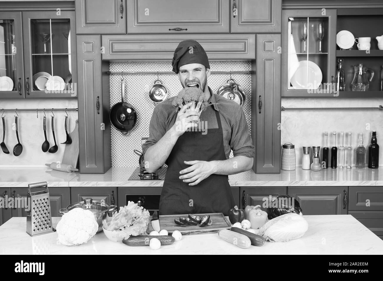 Go green. Handsome cook in kitchen. Chef following recipe. Cooking ...