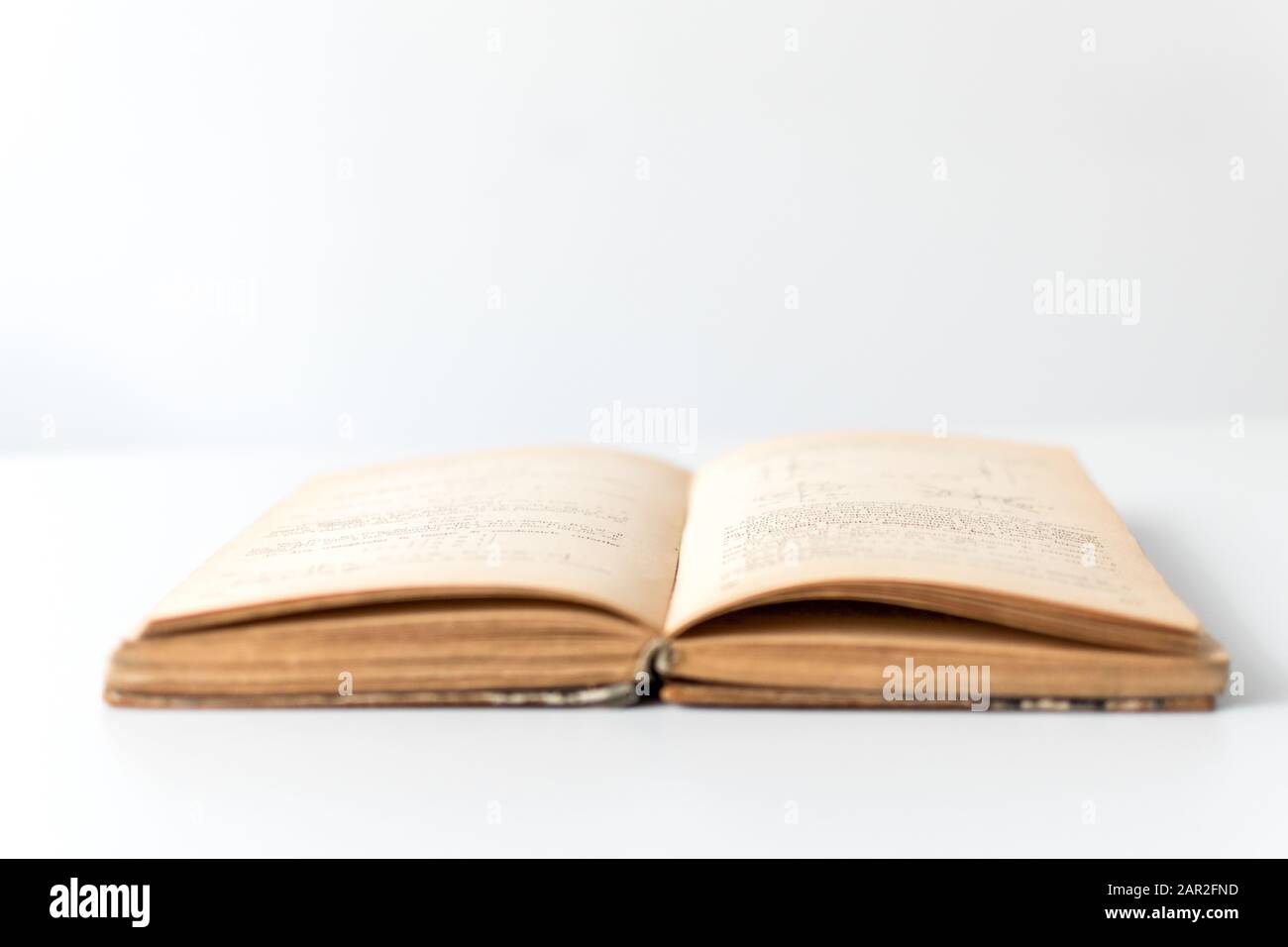 Close up shot of an open old science book containing equations and ...