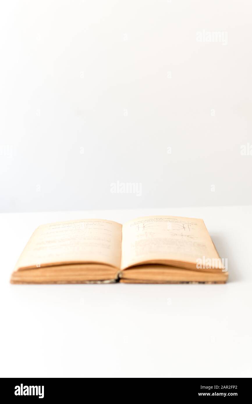 Close up shot of an open old science book containing equations and ...