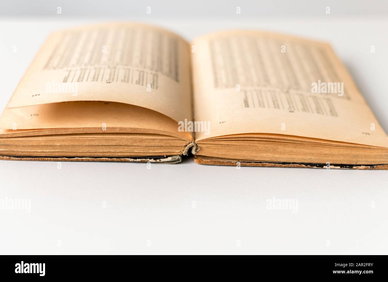 Close up shot of an open old science book containing equations and ...