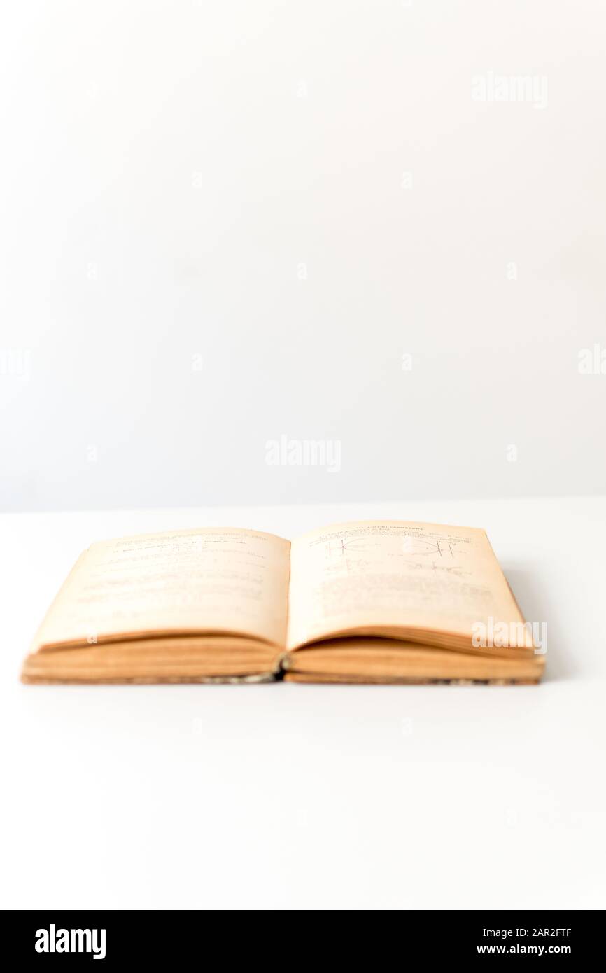 Close up shot of an open old science book containing equations and ...